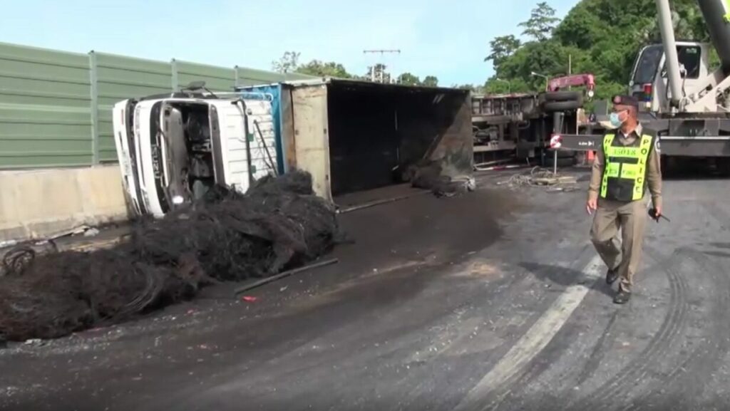 double accident A wire-carrying trailer overturned, a pickup truck ...
